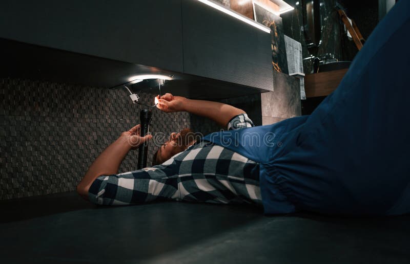 Using Flashlight. Fixing Water Tap Stock Photo - Image of plumber ...