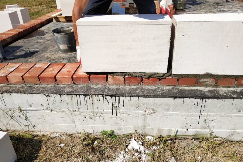 Using a Glue Solution, the Worker Begins To Build a Wall of Gas Blocks ...