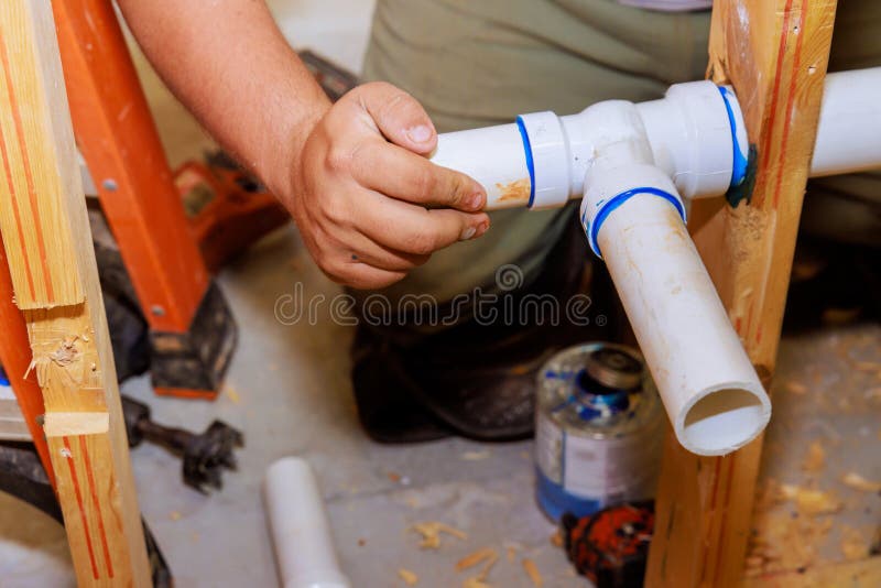 Using Glue To Join Plastic PVC Pipes, a Plumber Uses Stock Photo ...