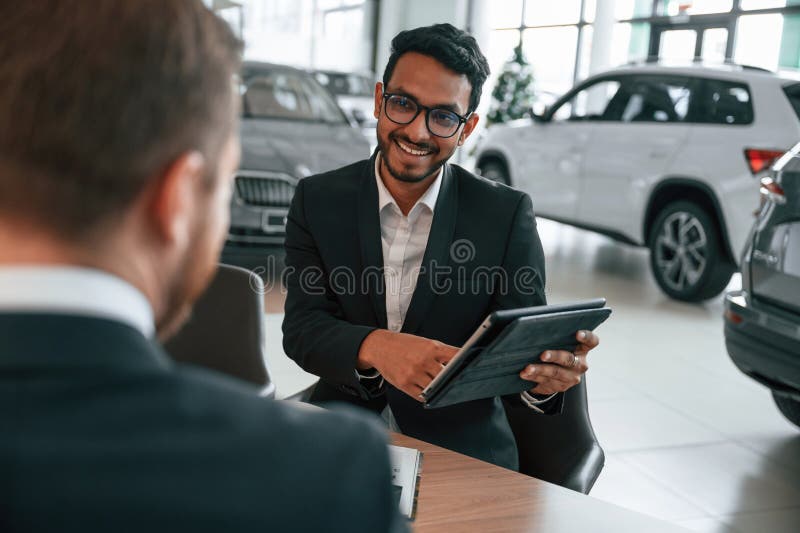 Using Graphic Tablet. Man is Consulting the Customer in the Car ...