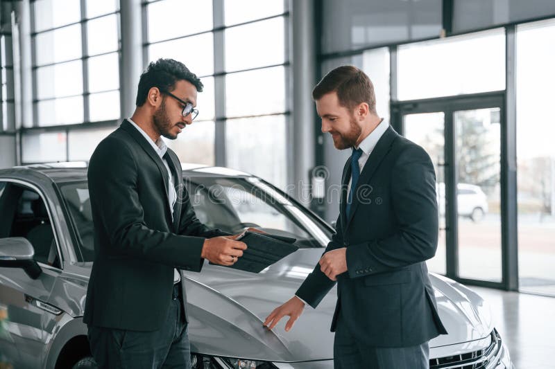 Using Graphic Tablet. Man is Consulting the Customer in the Car ...