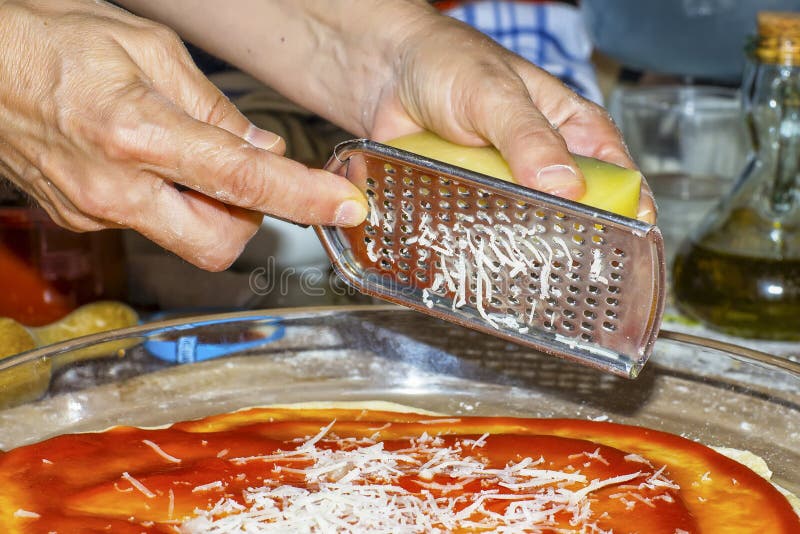Using a Grater To Grate Cheese Stock Image - Image of tomato, sauce ...