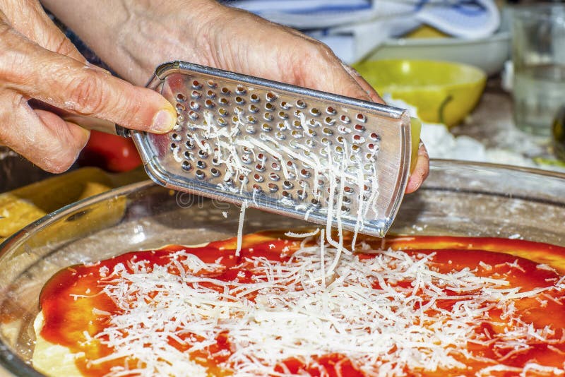 Using a Grater To Grate Cheese Stock Image - Image of tomato, sauce ...
