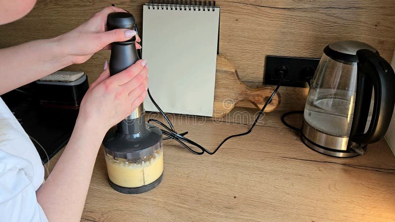 Using a Hand Blender To Mix Ingredients in the Kitchen Stock Photo ...