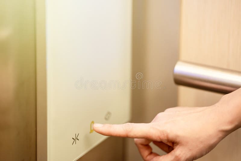 She is Using Her Index Finger To Press the Floor Number that Digital ...