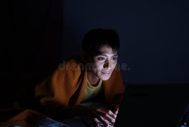 Using Laptop on Bed at Night Stock Image - Image of smile, dark: 13151993
