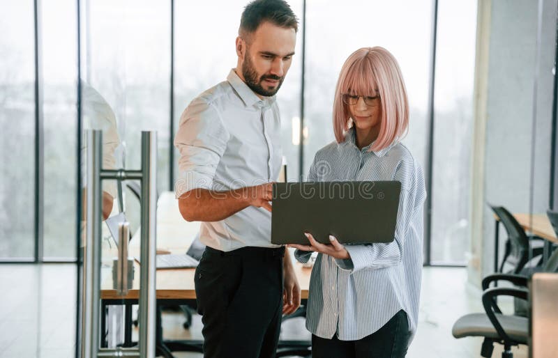 Using Laptop. Man and Woman are Working in the Office Together Stock ...