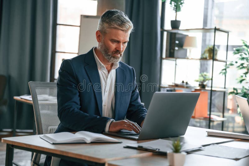 Using Laptop. Senior Businessman is Working in the Office Stock Photo ... Using Laptop. Senior Businessman is Working in the Office Stock Photo ...