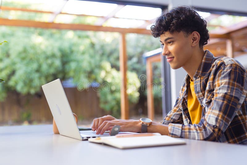 Using Laptop, Teenage Boy Working from Home at Desk with Notepad, Copy ...