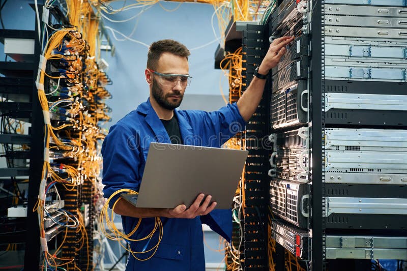 Using the Laptop. Young Man is Working with Internet Equipment and ...