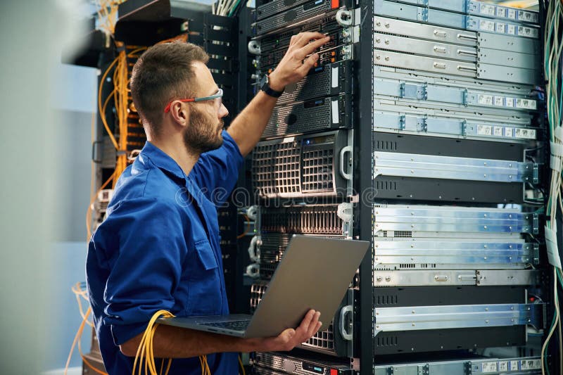 Using the Laptop. Young Man is Working with Internet Equipment and ...