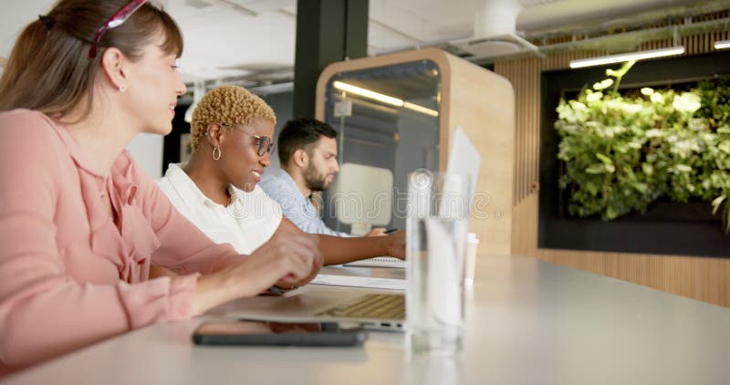 Using Laptops, Diverse Colleagues Collaborating on Project in Modern ...