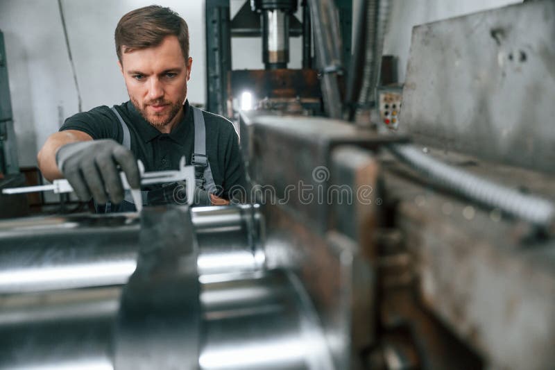 Using Measure Tool. Man in Uniform is in Workstation Developing Details ...