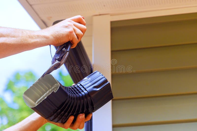 Using Metal Shears, a Worker Cuts Aluminum Rain Gutters before ...
