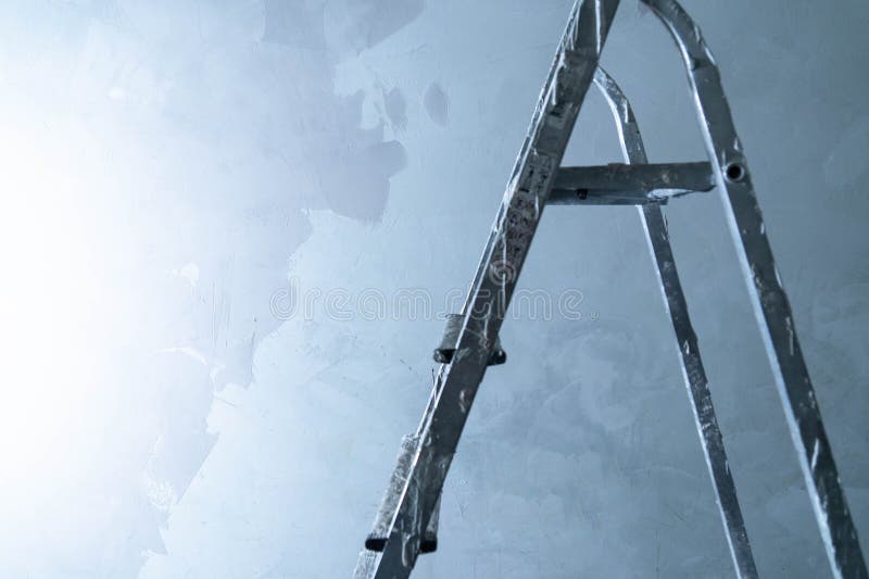 Repairing Surfaces with Microcement on a Ladder in a Well-lit Workspace ...