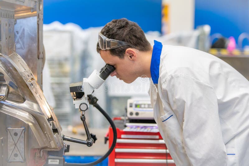 Using a Microscope while Working in a Research Center Stock Image ...