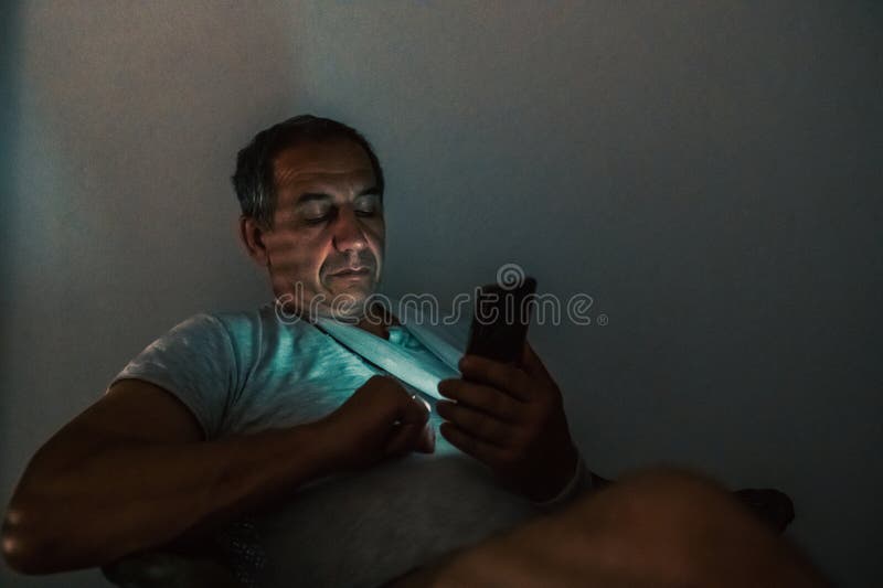 Using Mobile Apps Technology on Cell Phone Late at Night Stock Photo ...