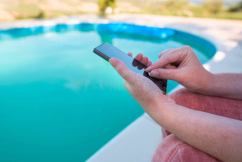 Using Mobile Phone by the Swimming Pool Stock Image - Image of blog ...