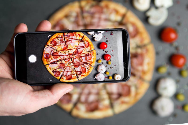 Using Mobile Phone To Photograph the Pizza . Pizza with Ingredients on ...