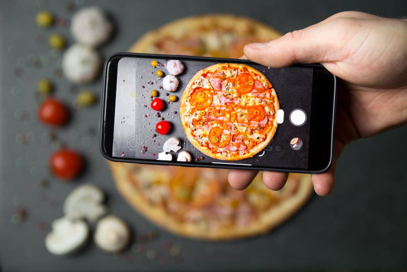 Using Mobile Phone To Photograph the Pizza . Pizza with Ingredients on ...