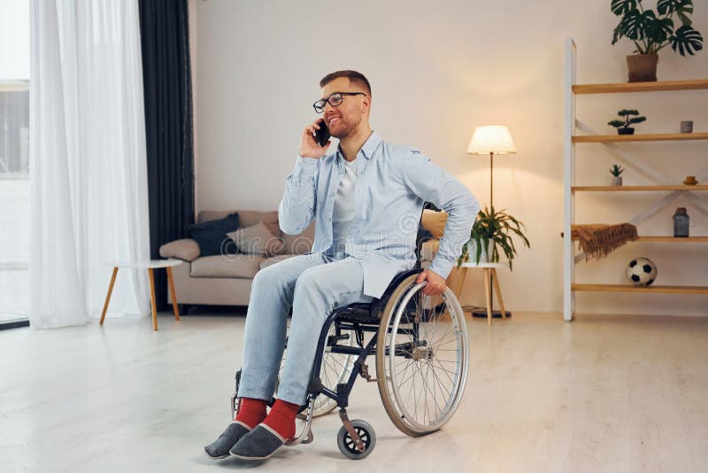 Using Phone. Disabled Man in Wheelchair is at Home Stock Image - Image ...