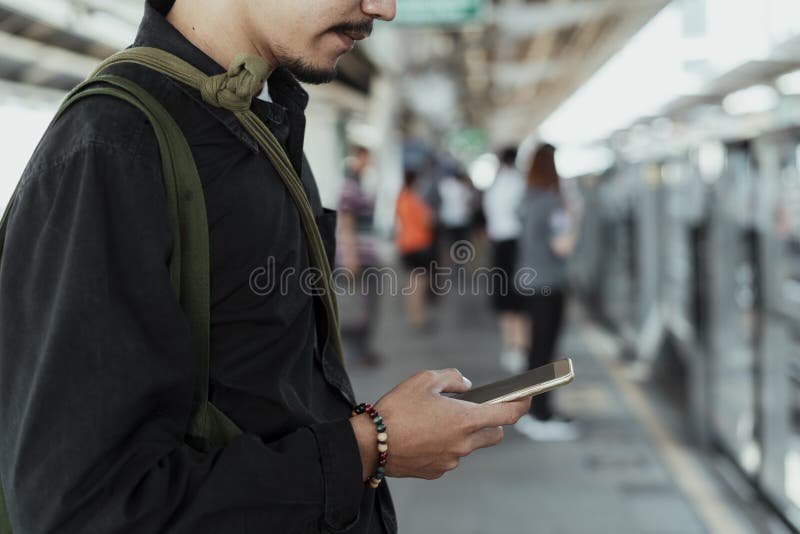 Using Phone while Waiting for Skytrain Stock Photo - Image of city ...