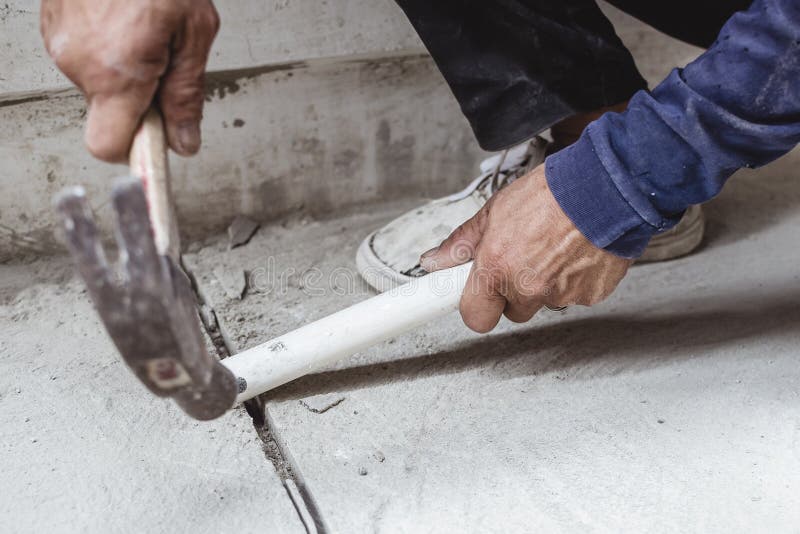 Using a Pipe with an Embedded Nail and a Hammer To Score the Concrete ...
