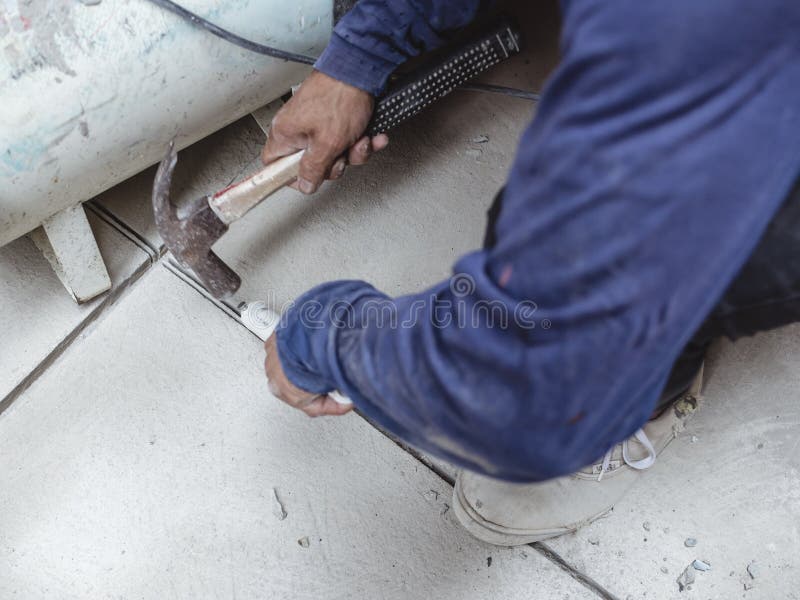 Using a Pipe with an Embedded Nail and a Hammer To Score the Concrete ...