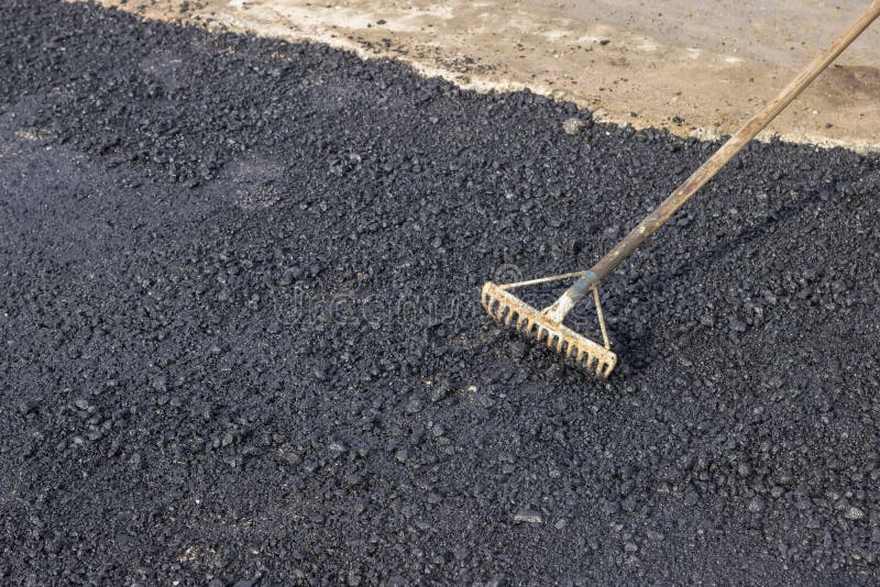 Using a Rake To Level Asphalt Pavement Stock Photo - Image of bitumen ...