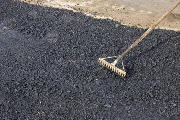 Using a Rake To Level Asphalt Pavement Stock Photo - Image of bitumen ...