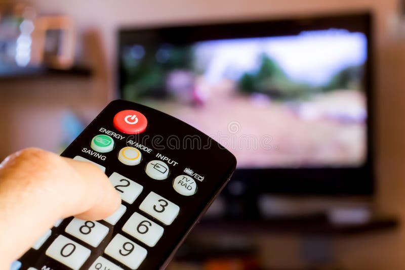 Using the Remote Control To Change Channesl on Tv Stock Photo - Image ...