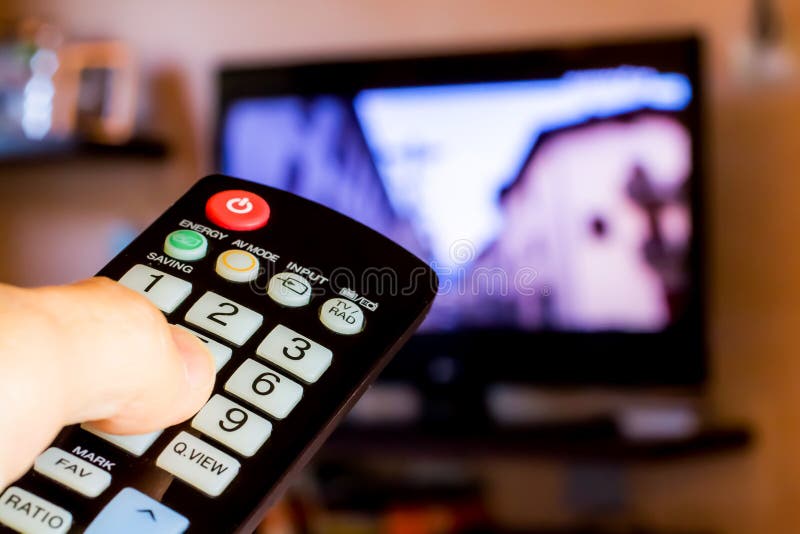 Using the Remote Control To Change Channesl on Tv Stock Photo - Image ...