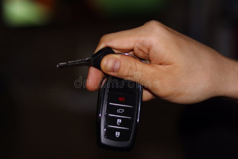 Using Right Hand, Grab Keys with Remote Control To Operate Stock Photo ...