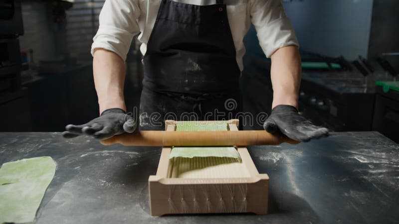 Using the Rolling Pin To Define the Shape of Green Spaghetti Stock ...