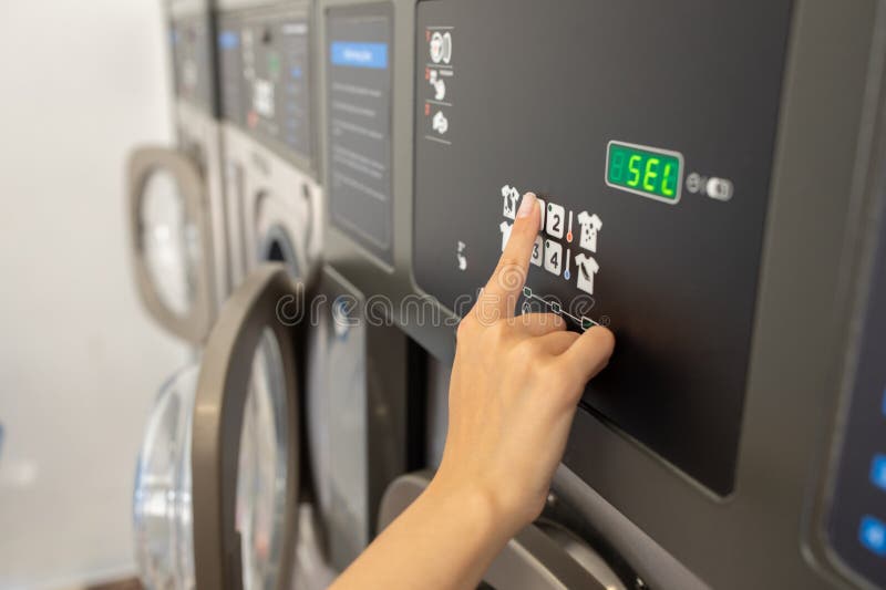 Using a Self-service Laundry Machine in a Laundromat for Quick Cleaning ...