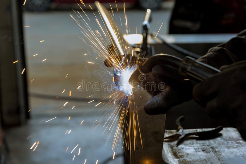 Using a Semi-automatic Argon Gas Shielded Welding Machine, the Worker ...