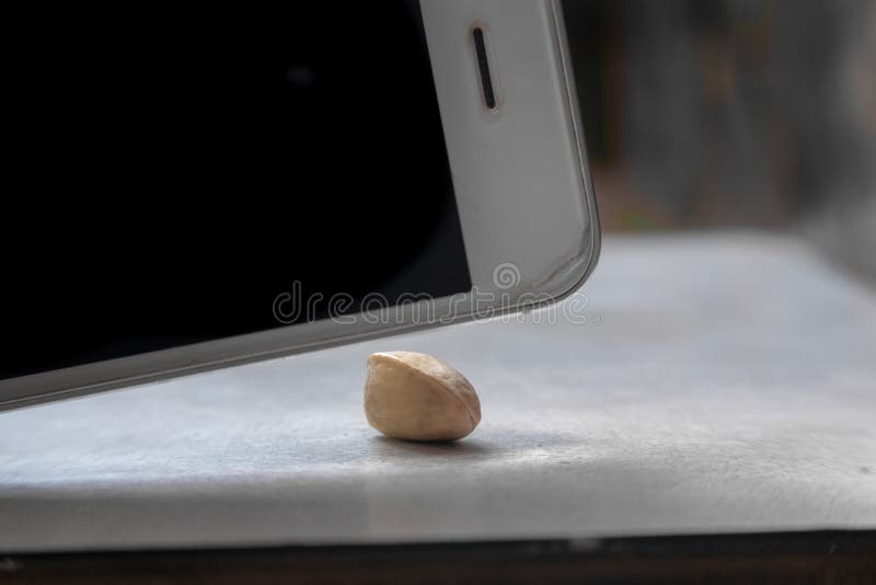 Using Smartphone As Nut Chopper. Phone Nutcracker. Phone and Nut ...