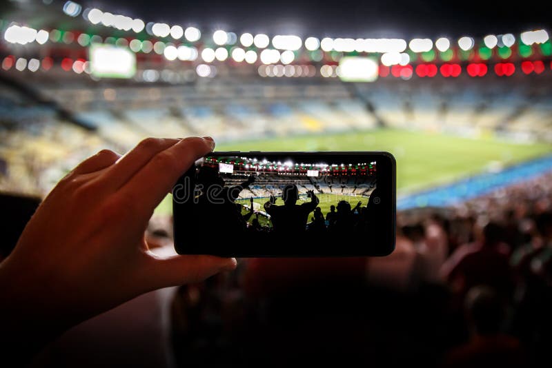 Using a Smartphone on Soccer Stadium Editorial Image - Image of phone ...