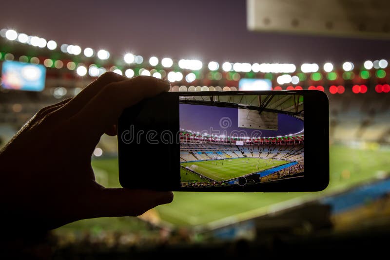 Using a Smartphone on Soccer Stadium Stock Photo - Image of connection ...
