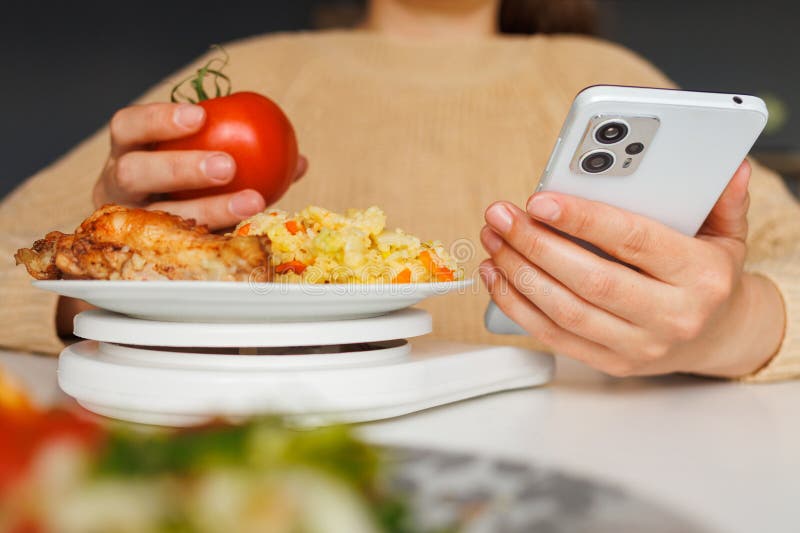 Using Smartphone while Weighing Tomato Over Meal on Kitchen Scale ...