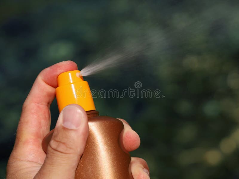 Using a Spray Bottle with Sunscreen Cream on the Beach, Concept of Skin ...