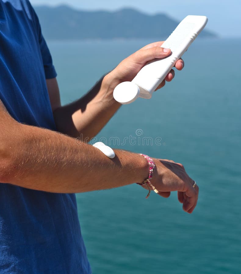 Using Sunscreen Cream on Arm Against Sea Under Sunlight Stock Image ...