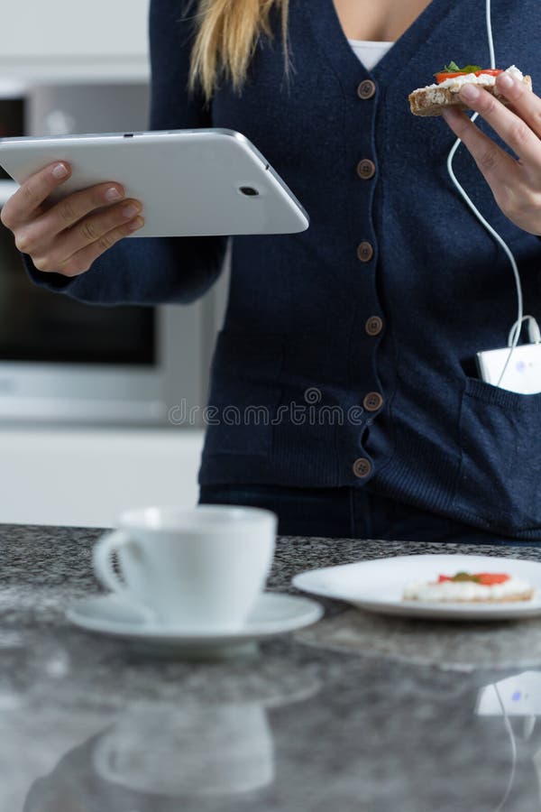 Using Tablet during Eating Sandwich Stock Image - Image of people ...