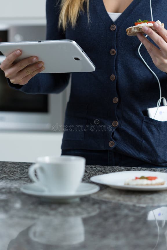 Using Tablet during Eating Sandwich Stock Image - Image of people ...