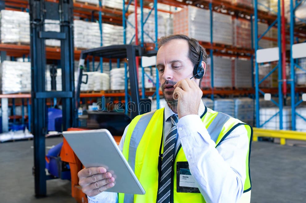 Using Tablet and Headset, Warehouse Manager Managing Inventory and ...