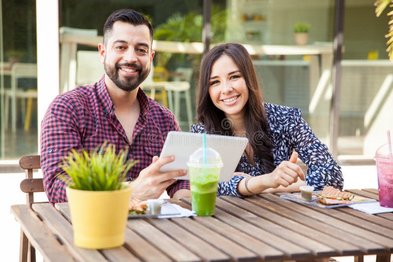 Using a Tablet during Lunch Stock Image - Image of date, cafe: 50320269