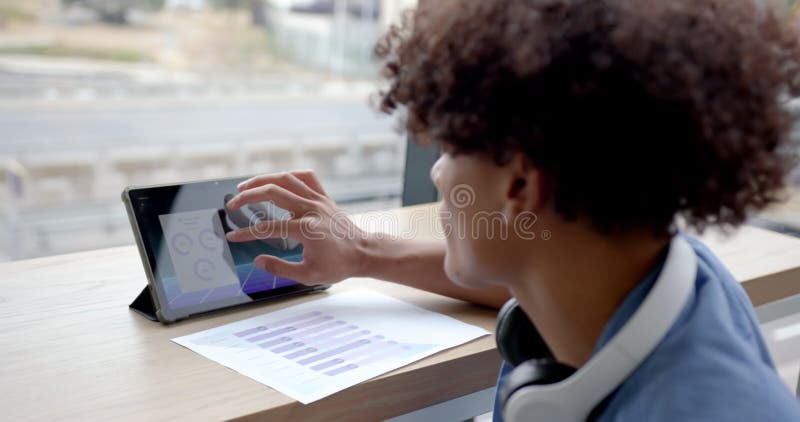 Using Tablet, Man Analyzing Data Charts with Headphones on Desk Stock Video - Video of ...