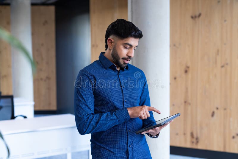 Using Tablet, Man in Blue Shirt Working in Modern Office Environment ...