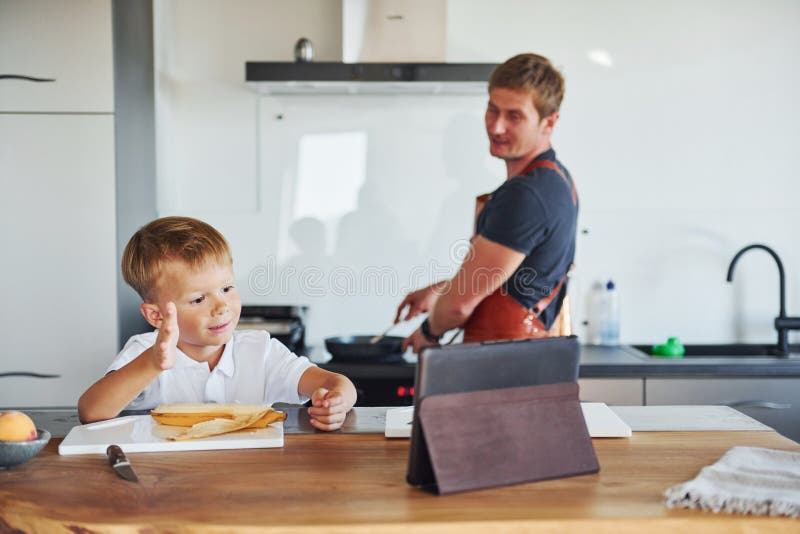 Learning How To Cook. Father and Son is Indoors at Home Together Stock ...