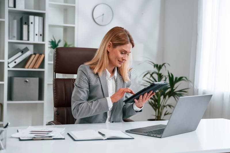 Using Tablet. Woman in Business Formal Clothes is Working in Office ...